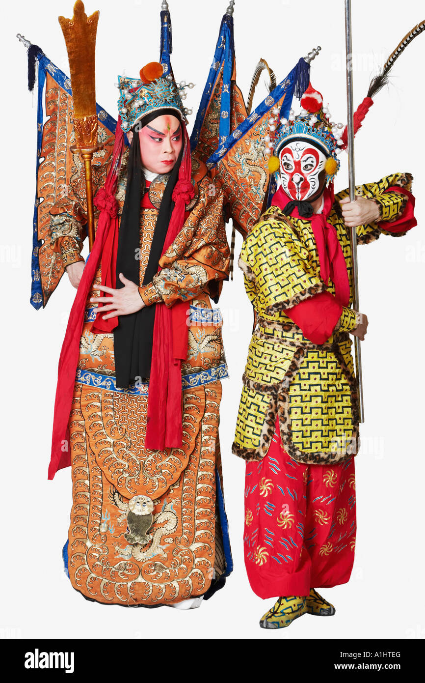 Two male Chinese opera performers gesturing with weapons Stock Photo ...