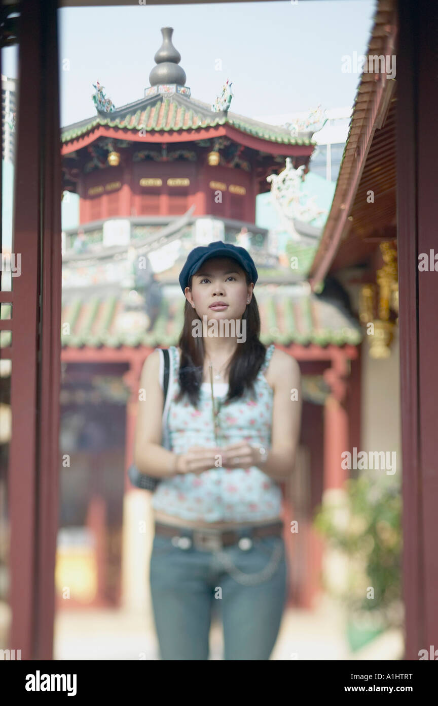 Young woman standing in front of a pagoda temple Stock Photo - Alamy