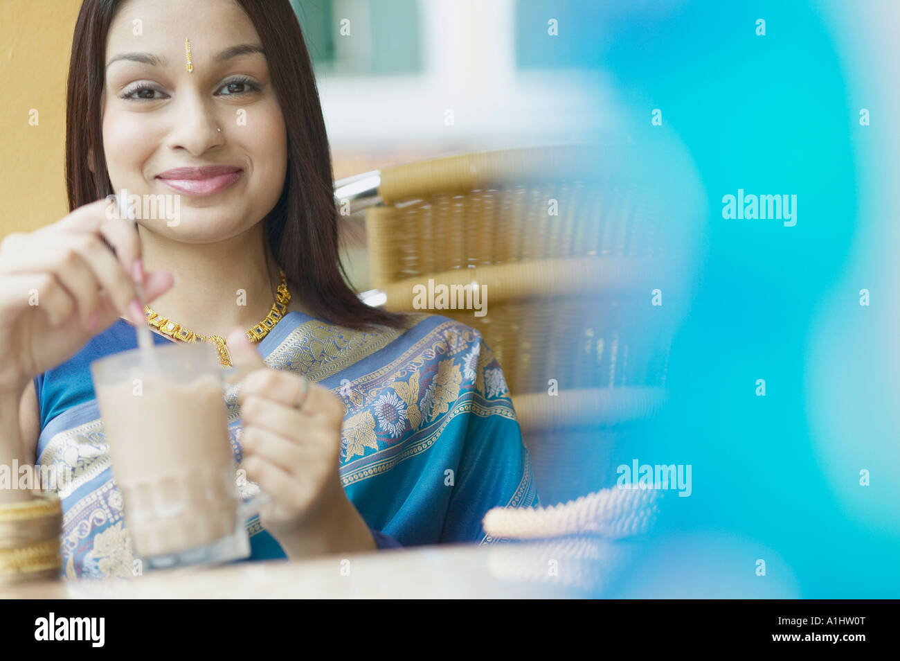 Portrait of a young woman drinking a milkshake Stock Photo - Alamy