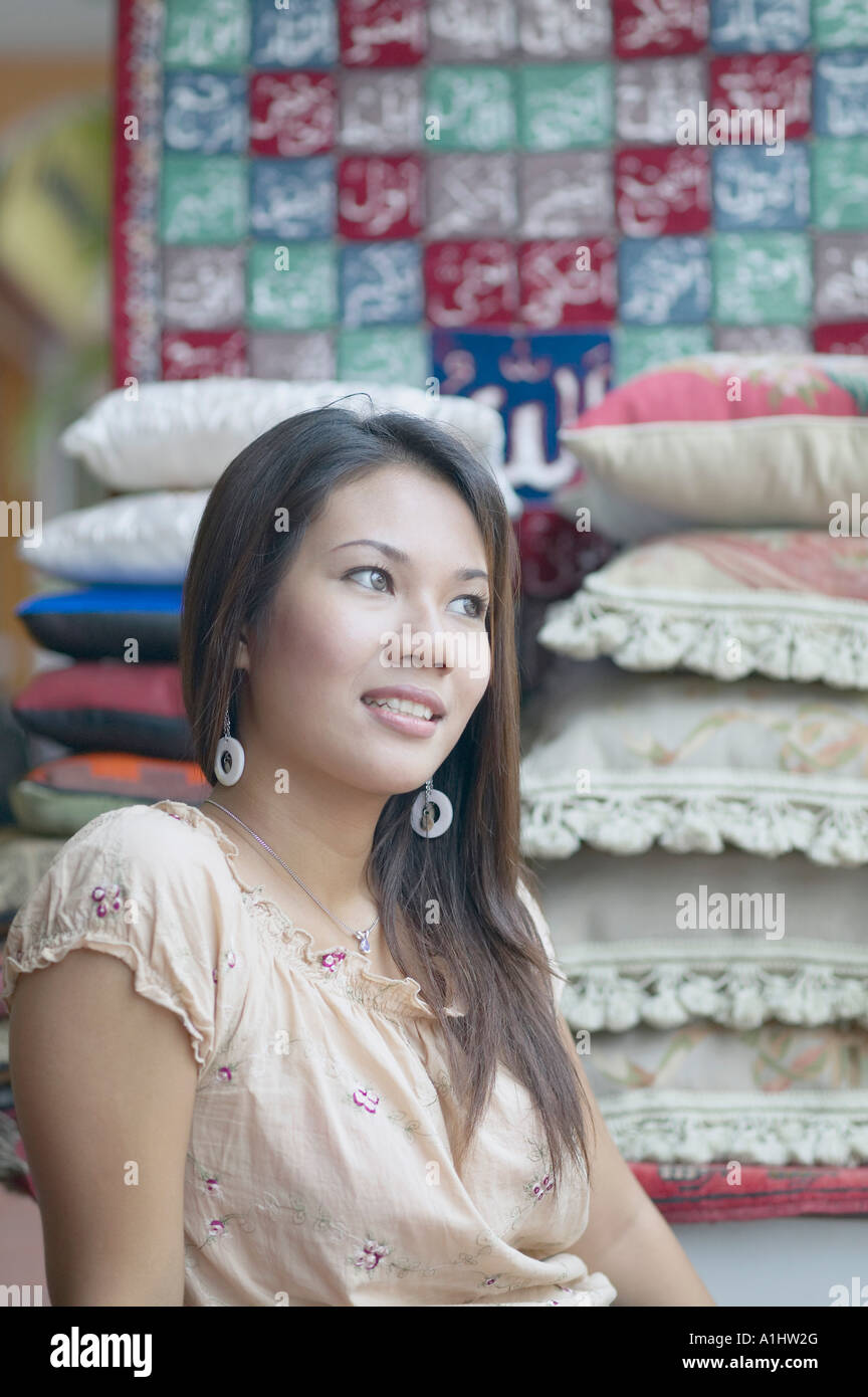 Side profile of a young woman in a clothing store Stock Photo - Alamy