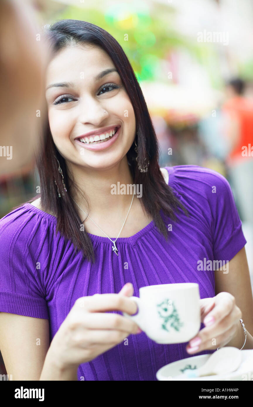 Woman smiles holding cup hi-res stock photography and images - Alamy