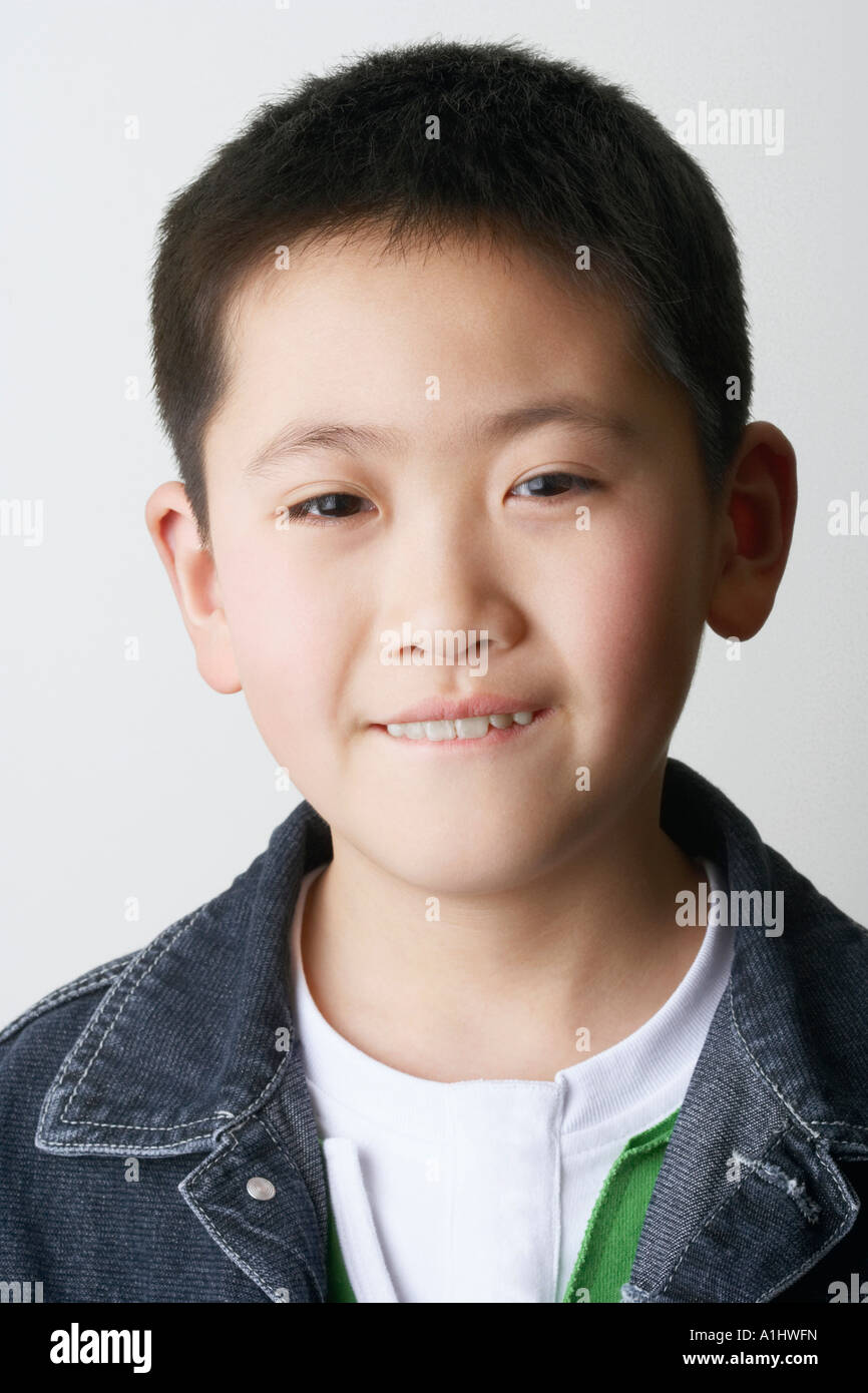 Portrait of a boy biting his lips Stock Photo - Alamy
