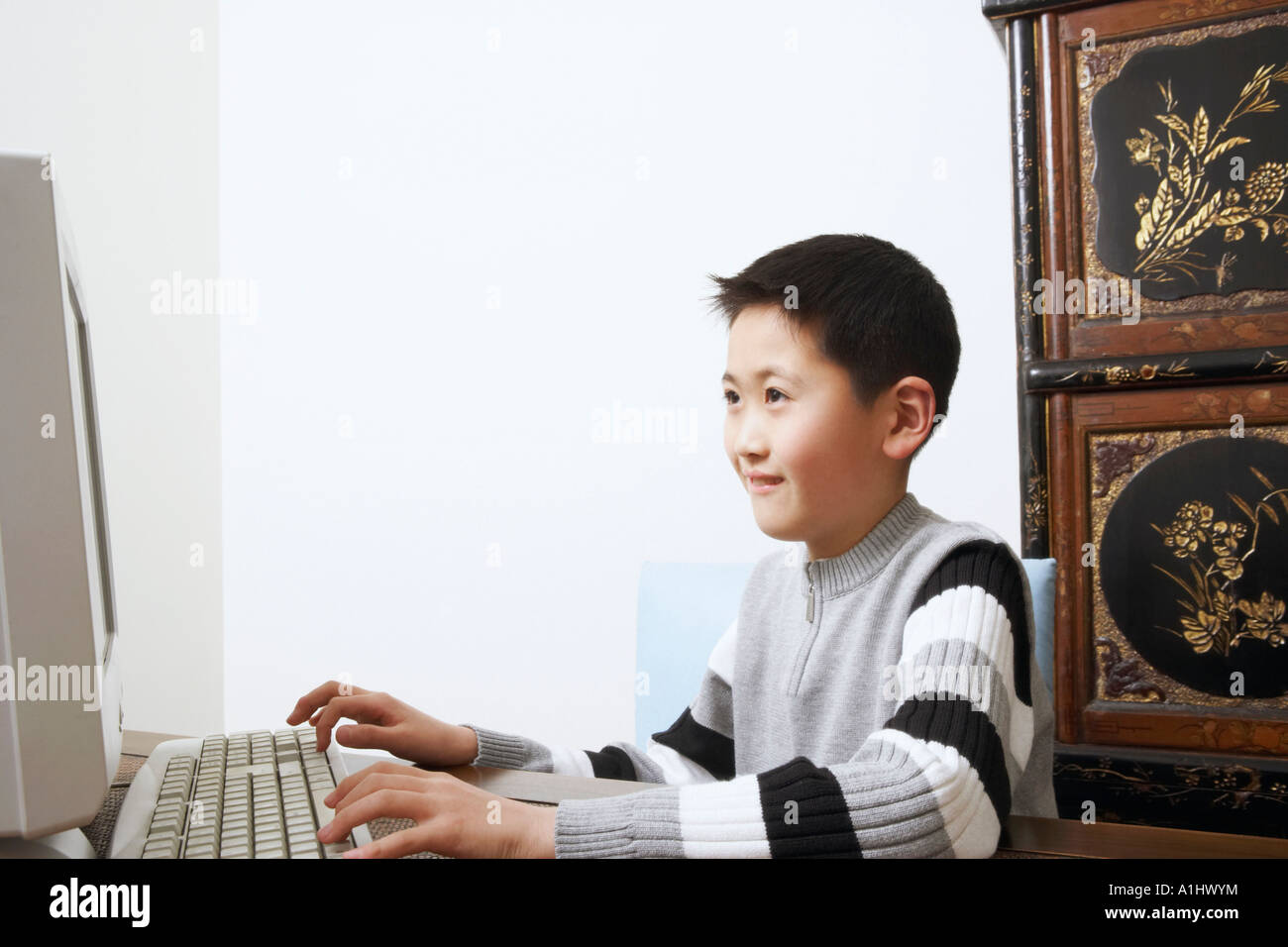 Close-up of a boy using a computer Stock Photo - Alamy