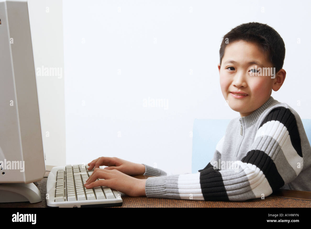 Portrait of a boy using a computer Stock Photo - Alamy
