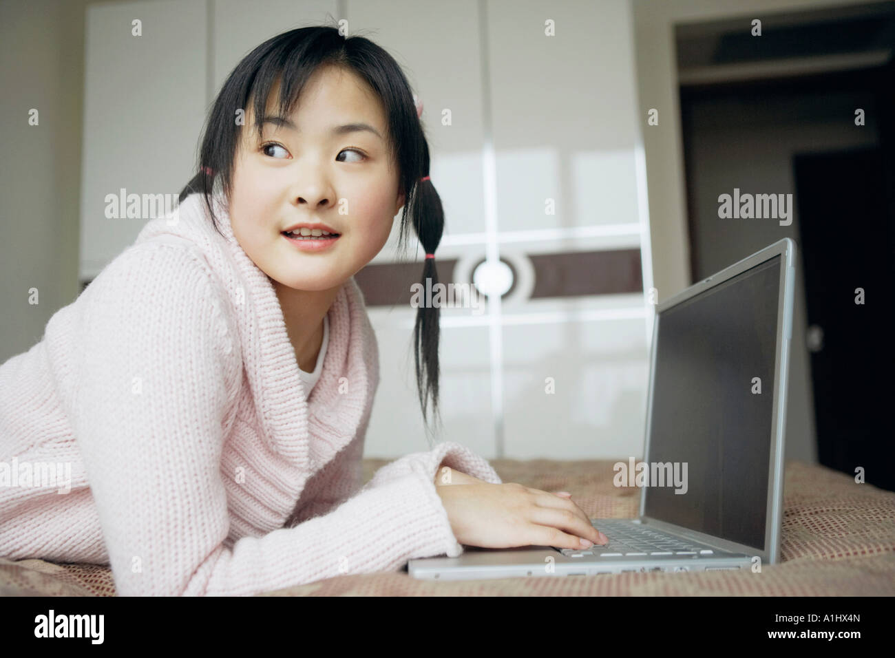Side profile of a young woman using a laptop Stock Photo - Alamy