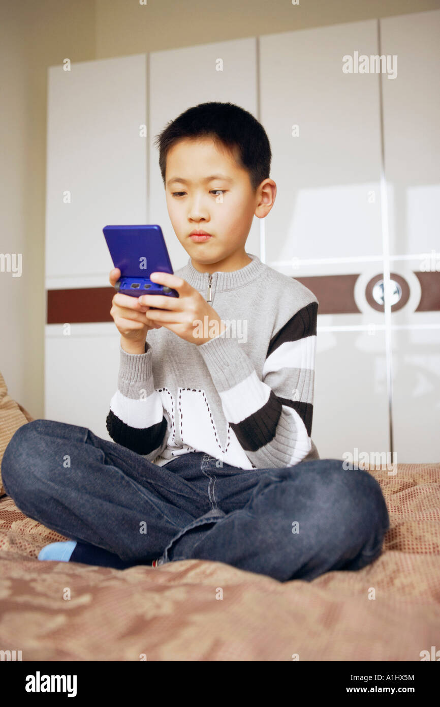 Boy playing a video game Stock Photo - Alamy