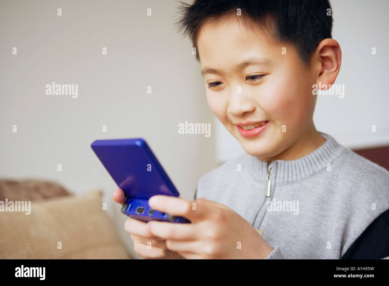 Close-up of a boy playing a video game Stock Photo - Alamy