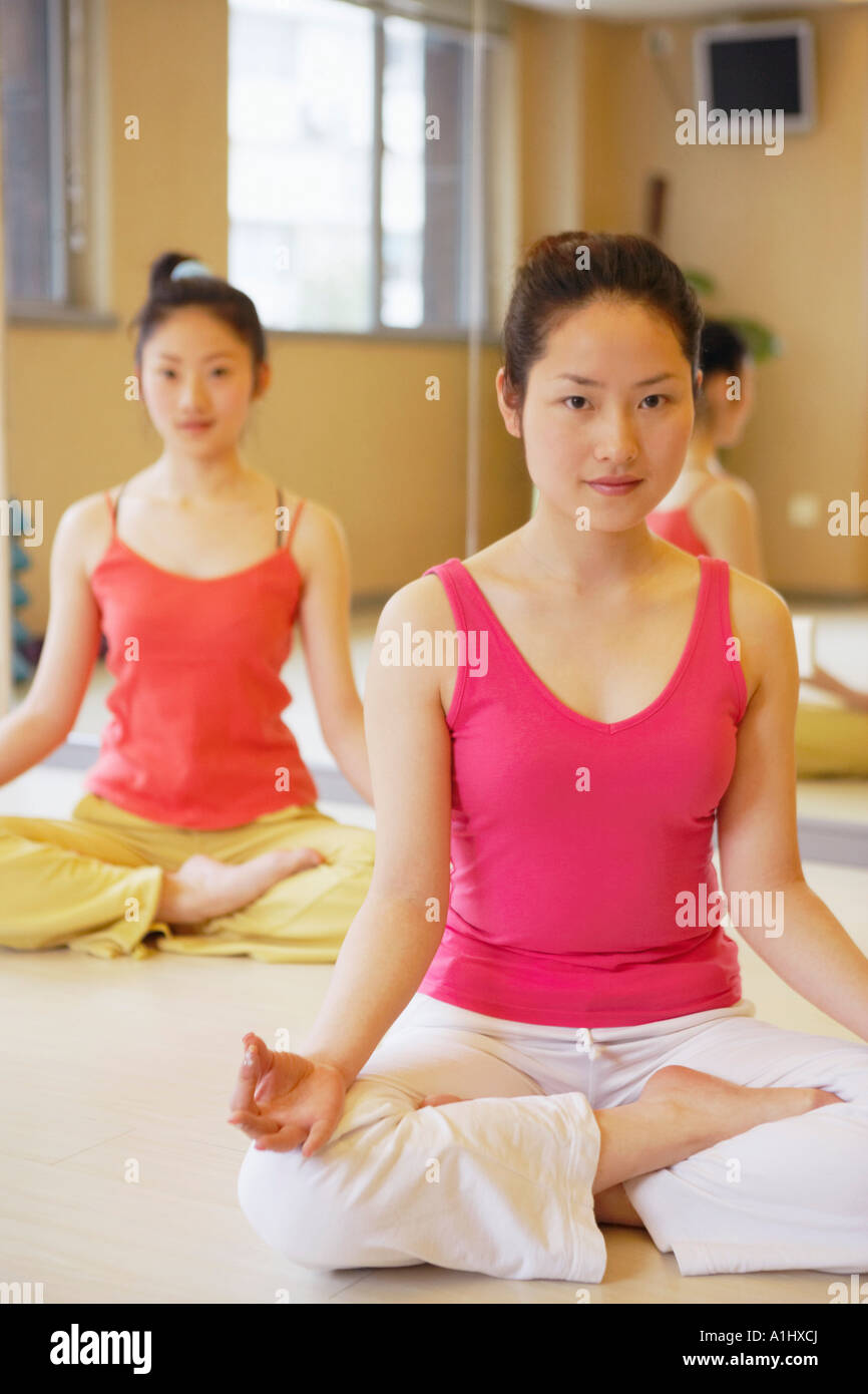 Portrait of a young woman sitting in the lotus position Stock Photo - Alamy