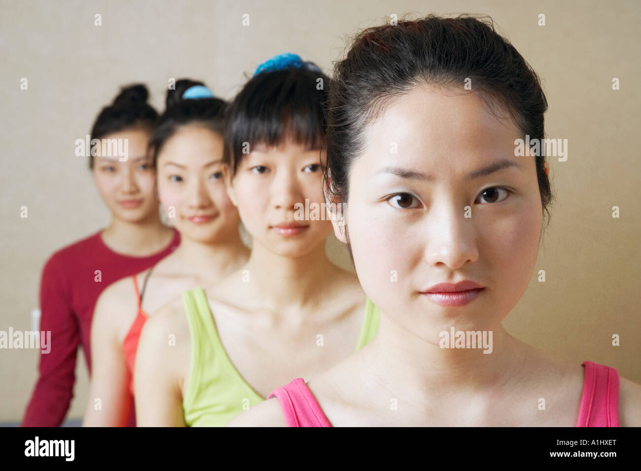 Portrait of four young women in a row Stock Photo - Alamy