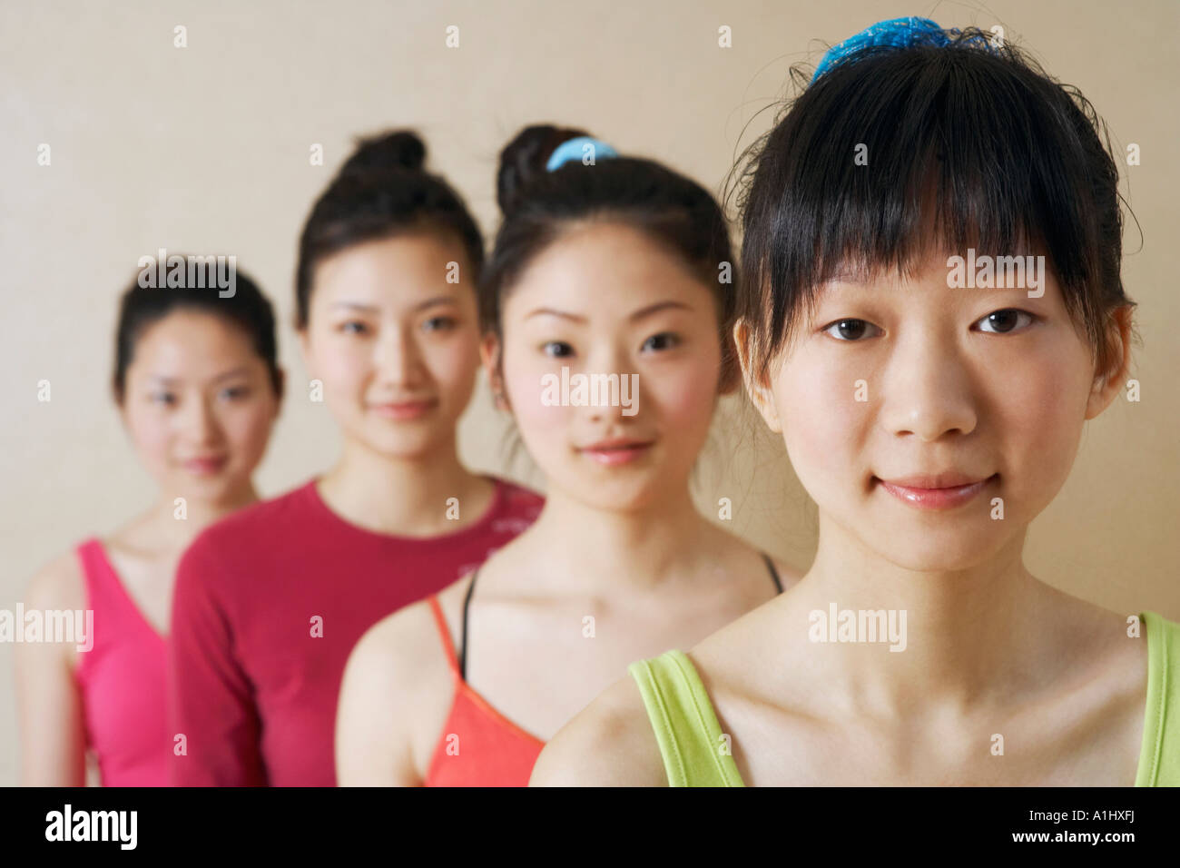 Portrait of four young women in a row Stock Photo - Alamy