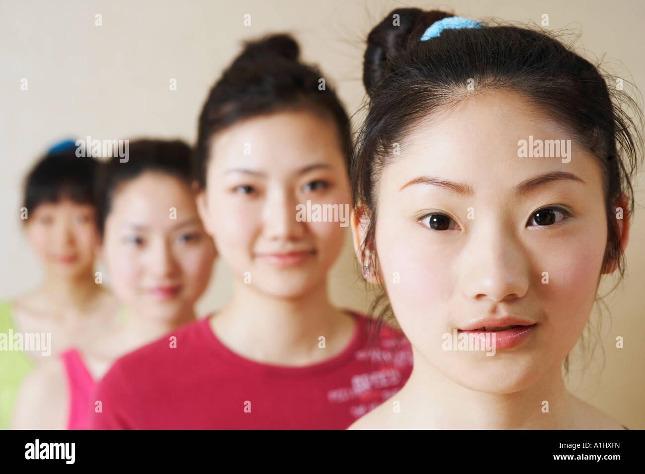 Portrait of four young women in a row Stock Photo - Alamy