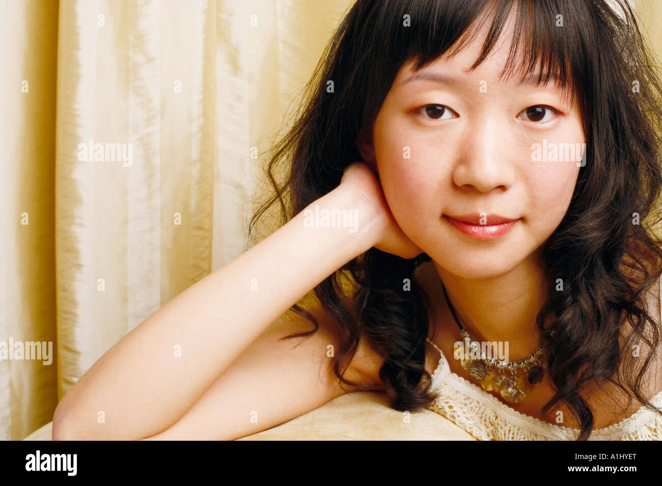 Portrait of a young woman thinking with her hands on her cheek Stock ...
