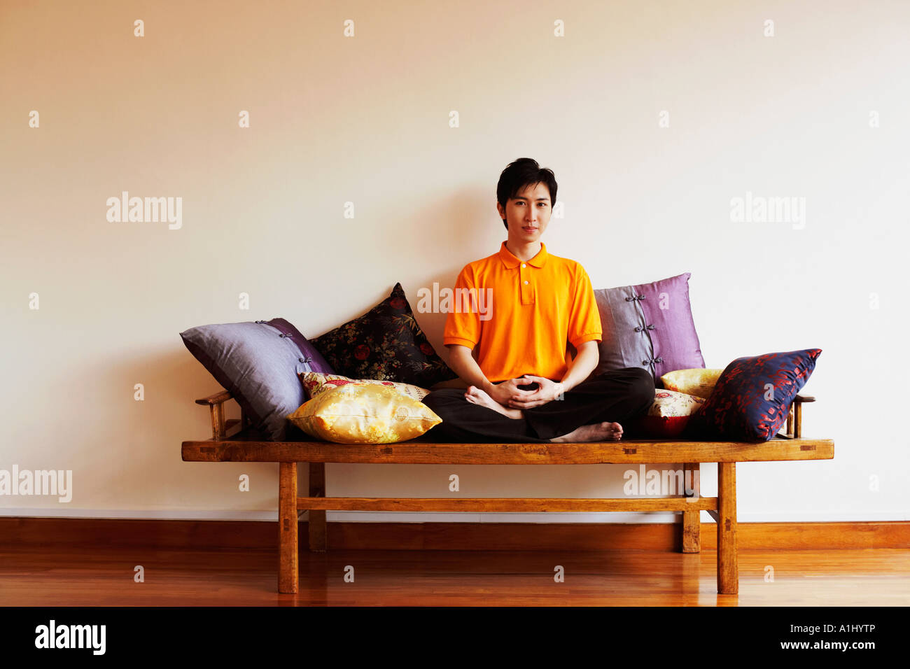 Portrait of a young man sitting on a bench Stock Photo - Alamy