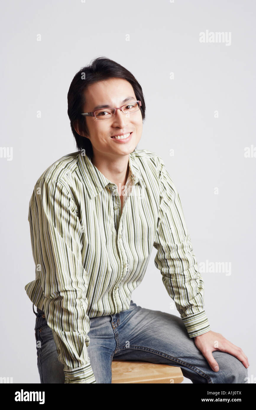 Black man sitting on a stool hi-res stock photography and images - Alamy