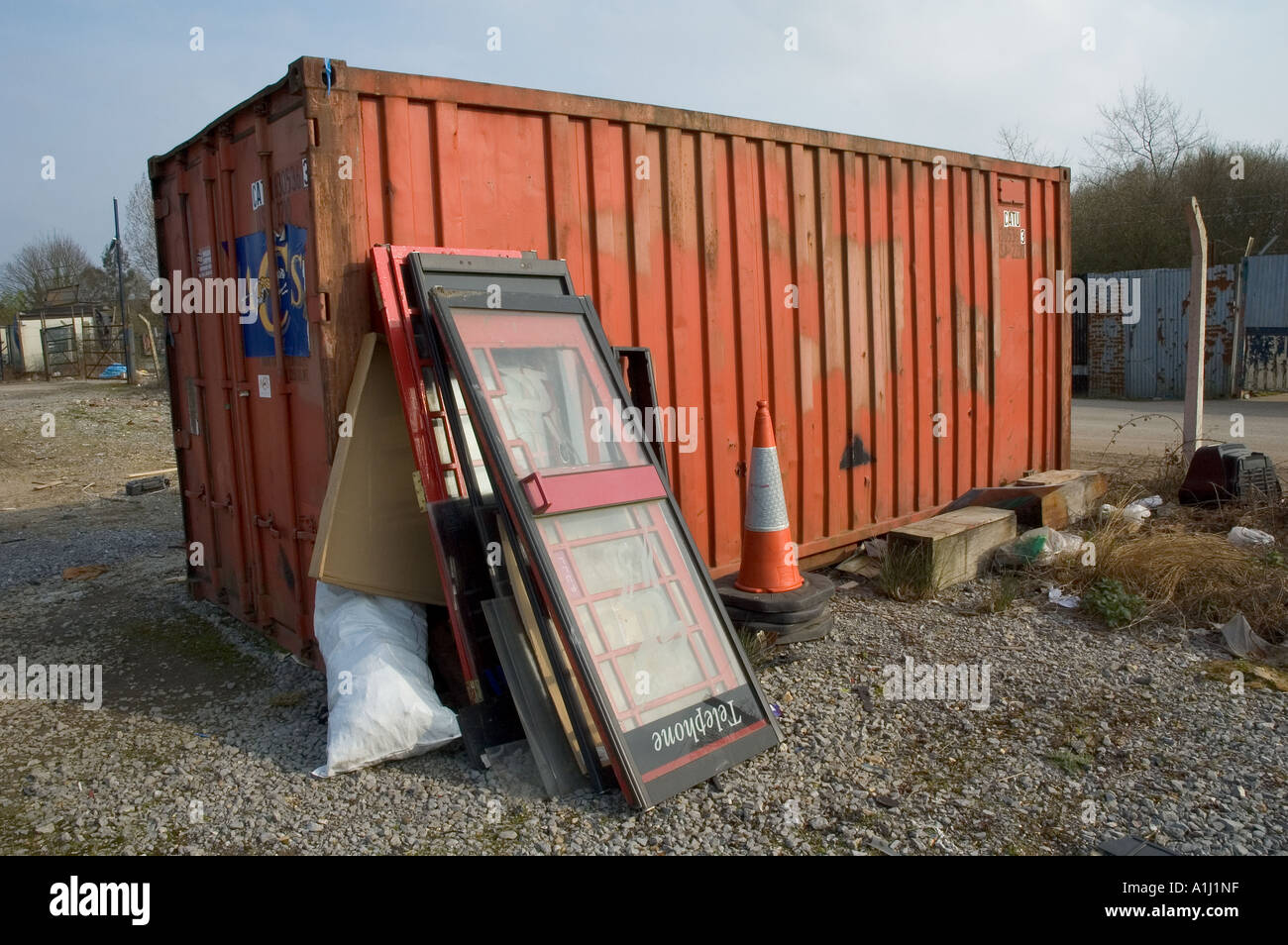 scrapyard debris - container and phone box doors Stock Photo - Alamy