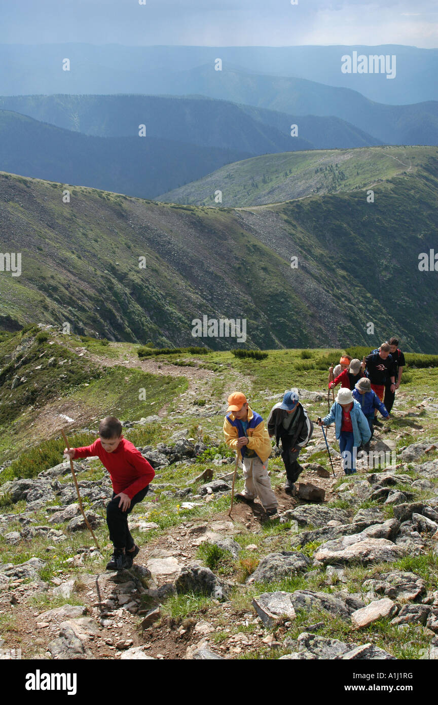 Young trekkers climbing up to the summit of Chersky Peak (2090) in the ...