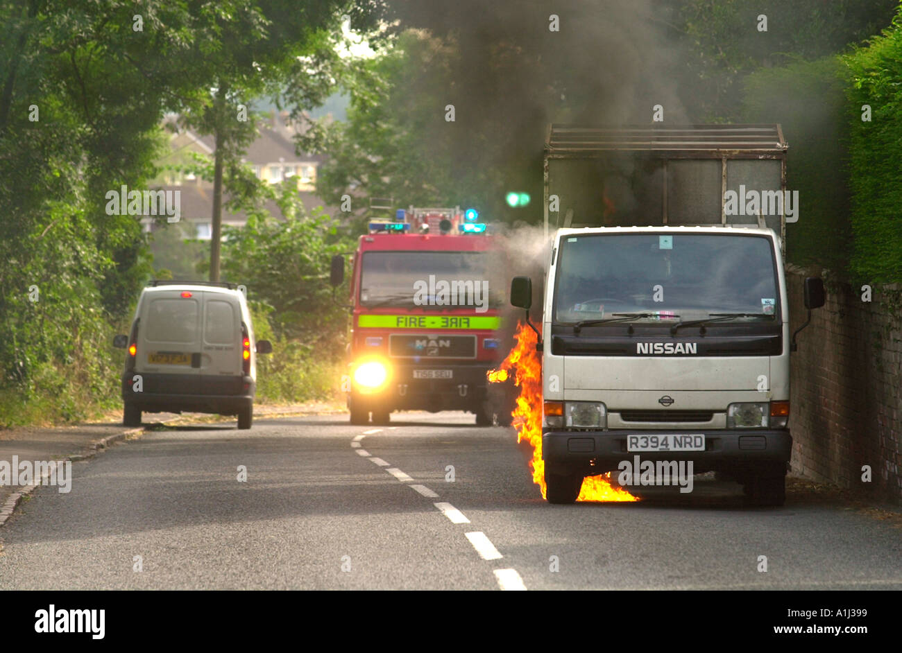 A FIRE ENGINE APPROACHES A LORRY ON FIRE UK Stock Photo - Alamy