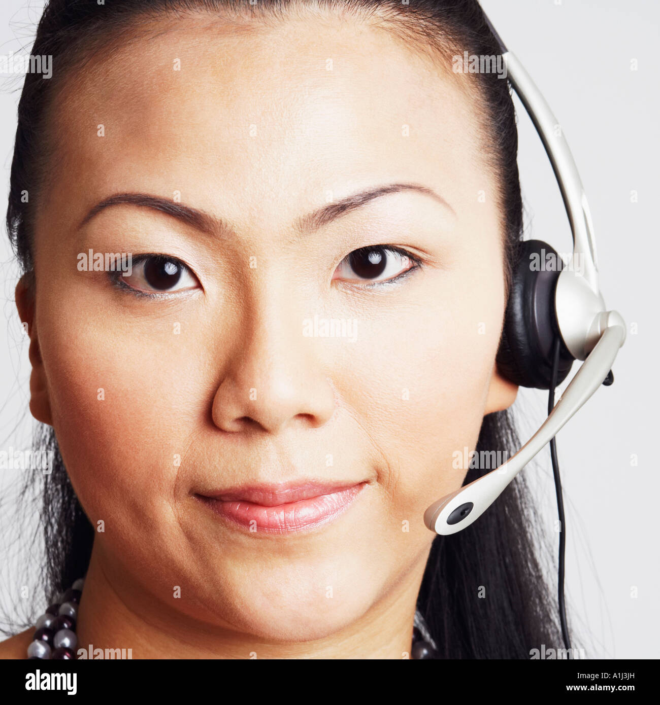 Portrait of a young woman wearing a headset Stock Photo - Alamy