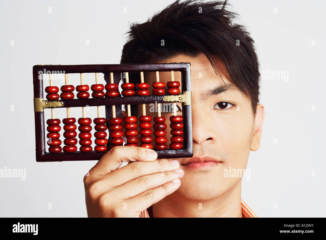 Portrait of a young man holding an abacus Stock Photo - Alamy
