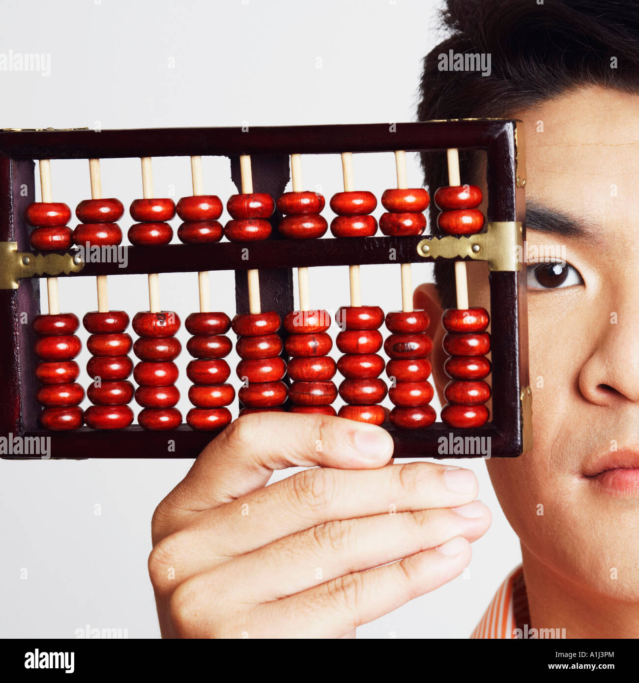 Portrait of a young man holding an abacus Stock Photo - Alamy