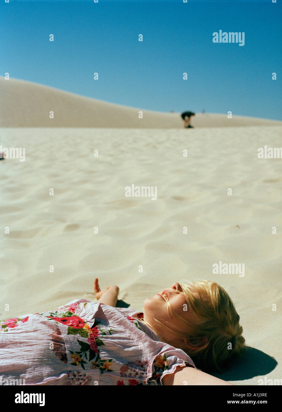 Girl lying on sand hi-res stock photography and images - Alamy