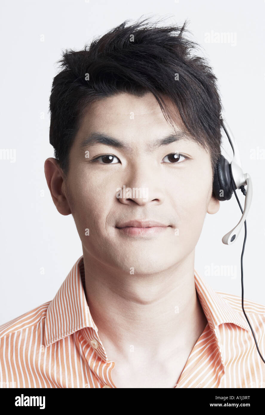Portrait of a young man wearing a headset Stock Photo - Alamy