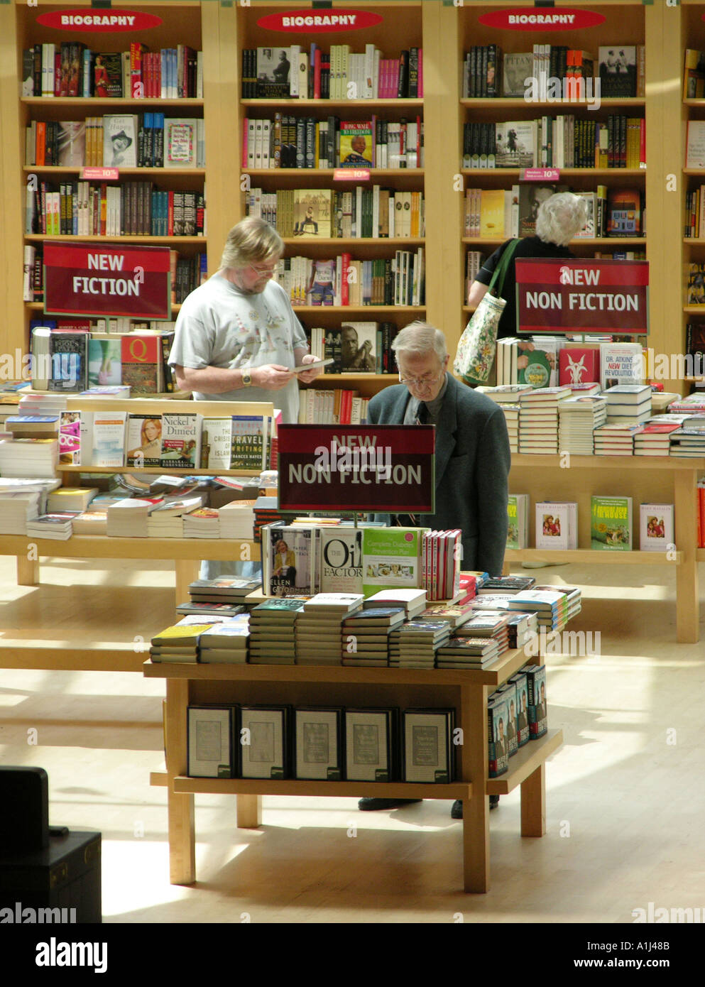 Adults looks for books at a Georgetown Washington D C bookstore Stock ...