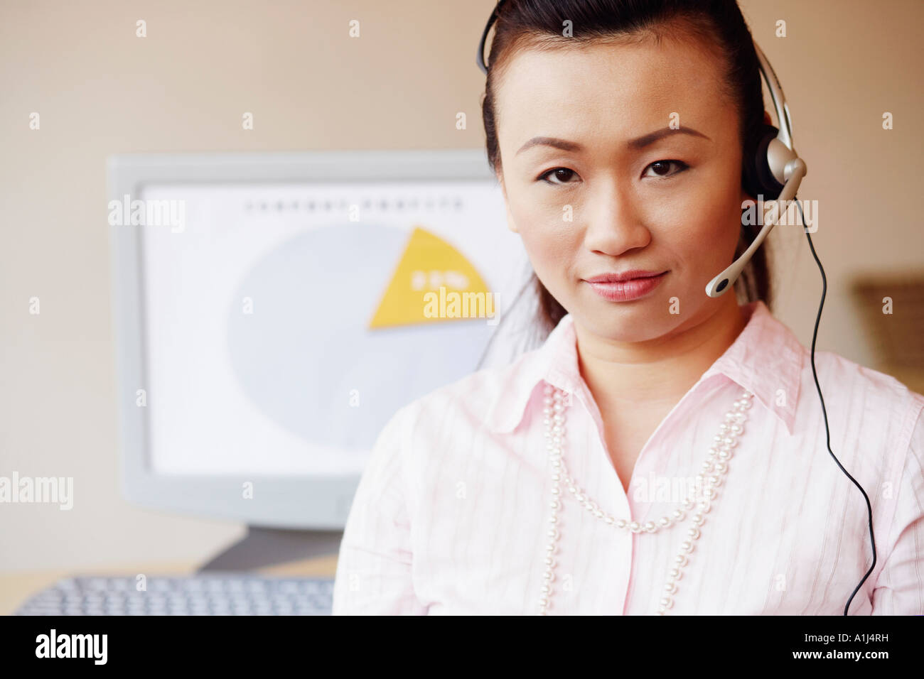 Portrait of a female customer service representative talking on a ...