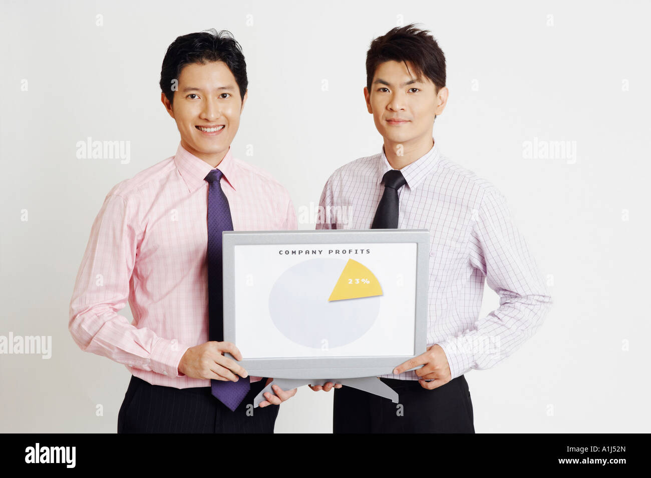Portrait of two businessmen holding a progress report and smiling Stock ...