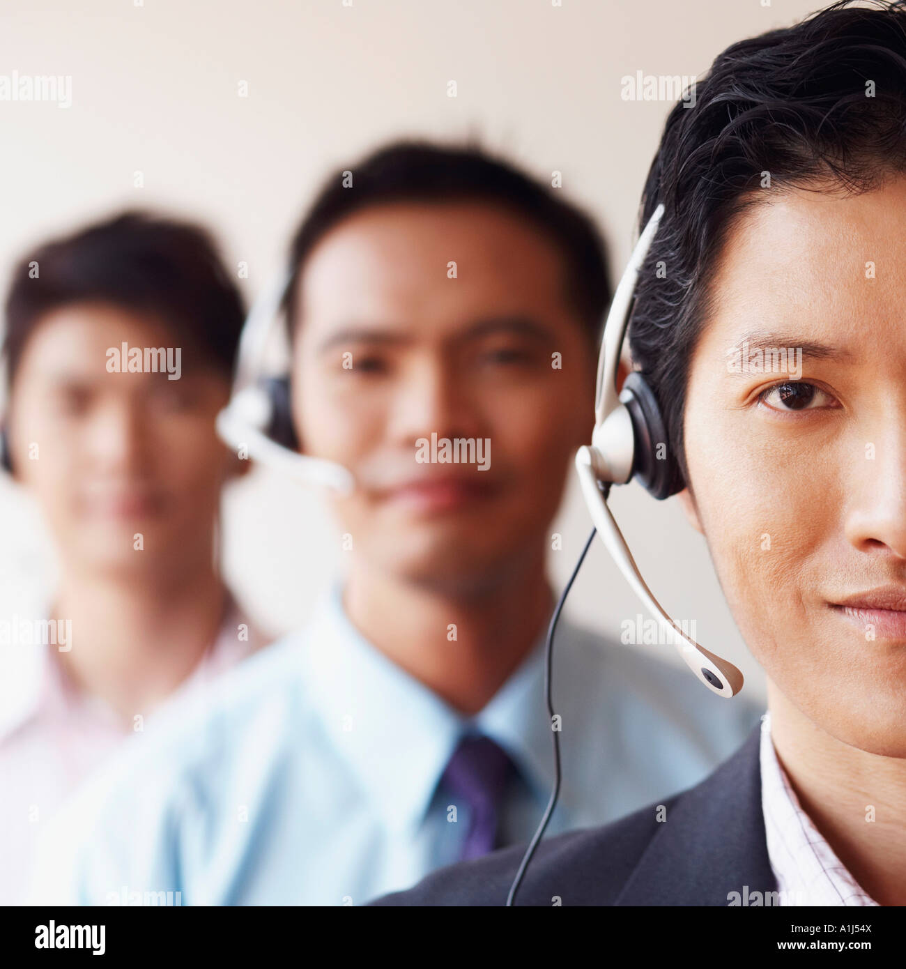 Portrait of three male customer service representatives Stock Photo - Alamy