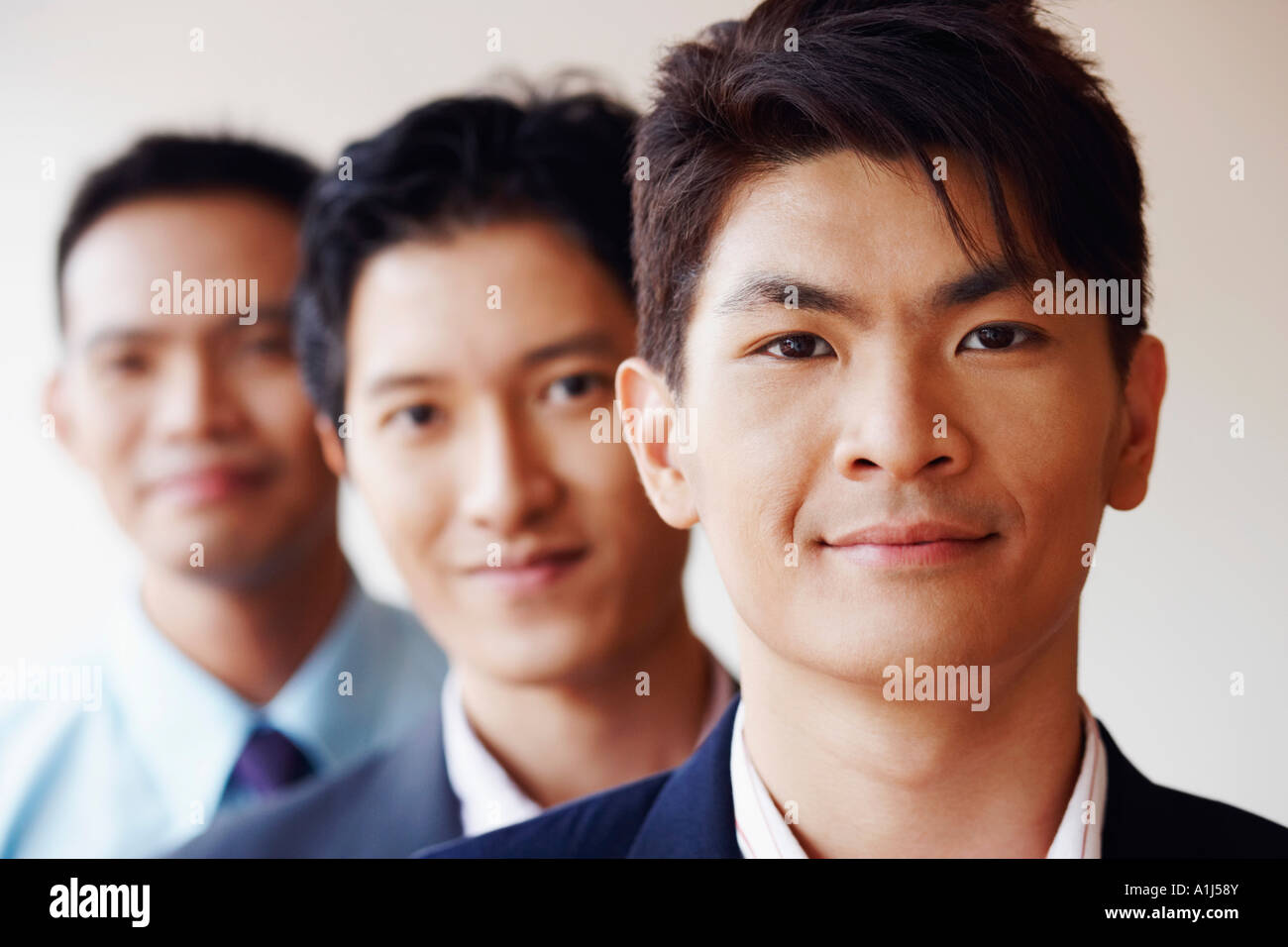 Portrait of three businessmen smiling Stock Photo - Alamy