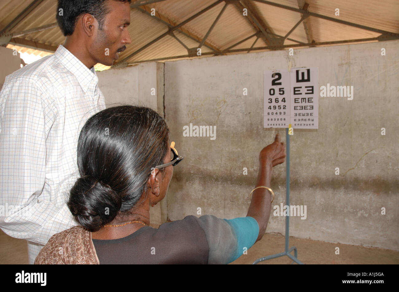 A woman has a free eye test at a screening camp in a village in ...