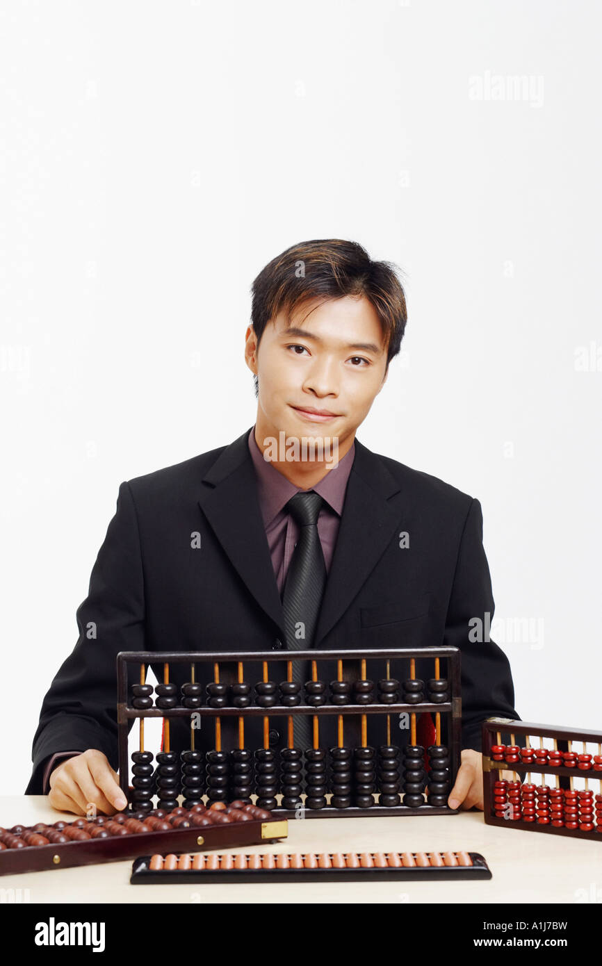 Portrait of a businessman with four abacuses Stock Photo - Alamy