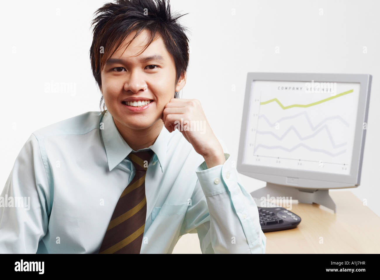 Portrait of a businessman smiling with a progress report in the ...