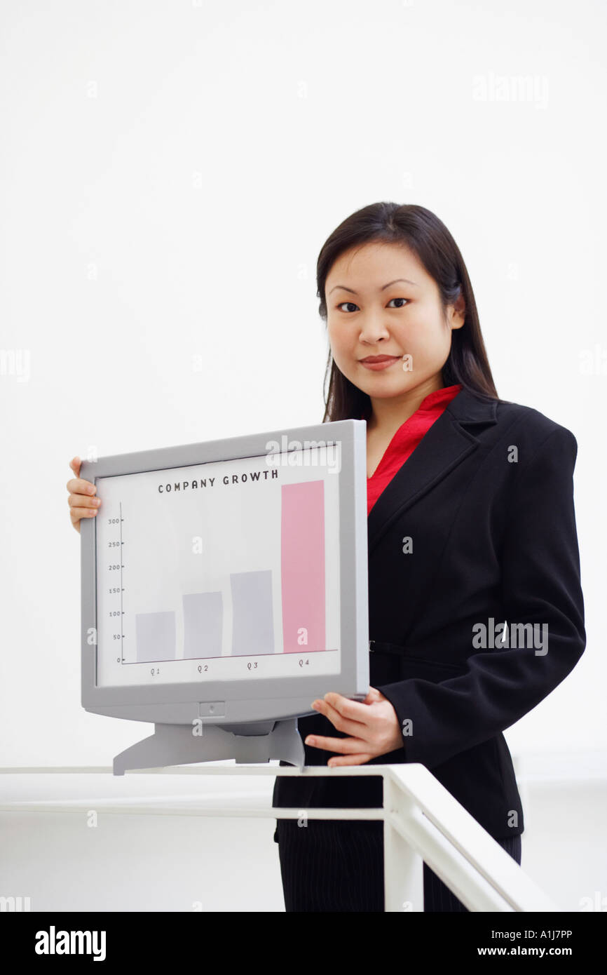 Portrait of a businesswoman showing a growth chart Stock Photo - Alamy