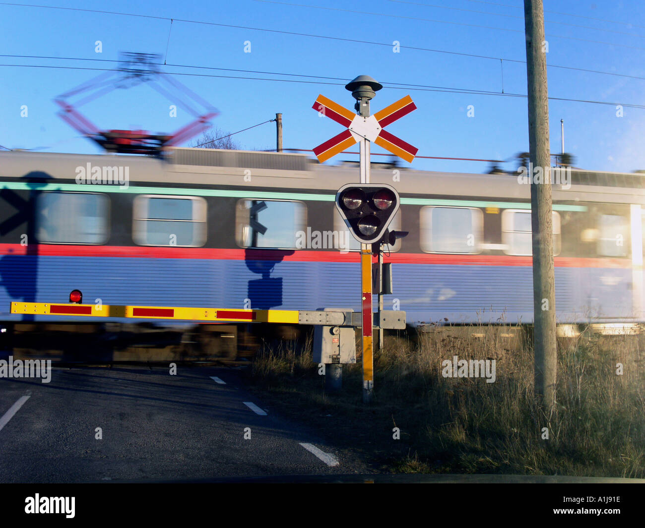 Unmanned level crossing in rural Halland Sweden with train passing ...