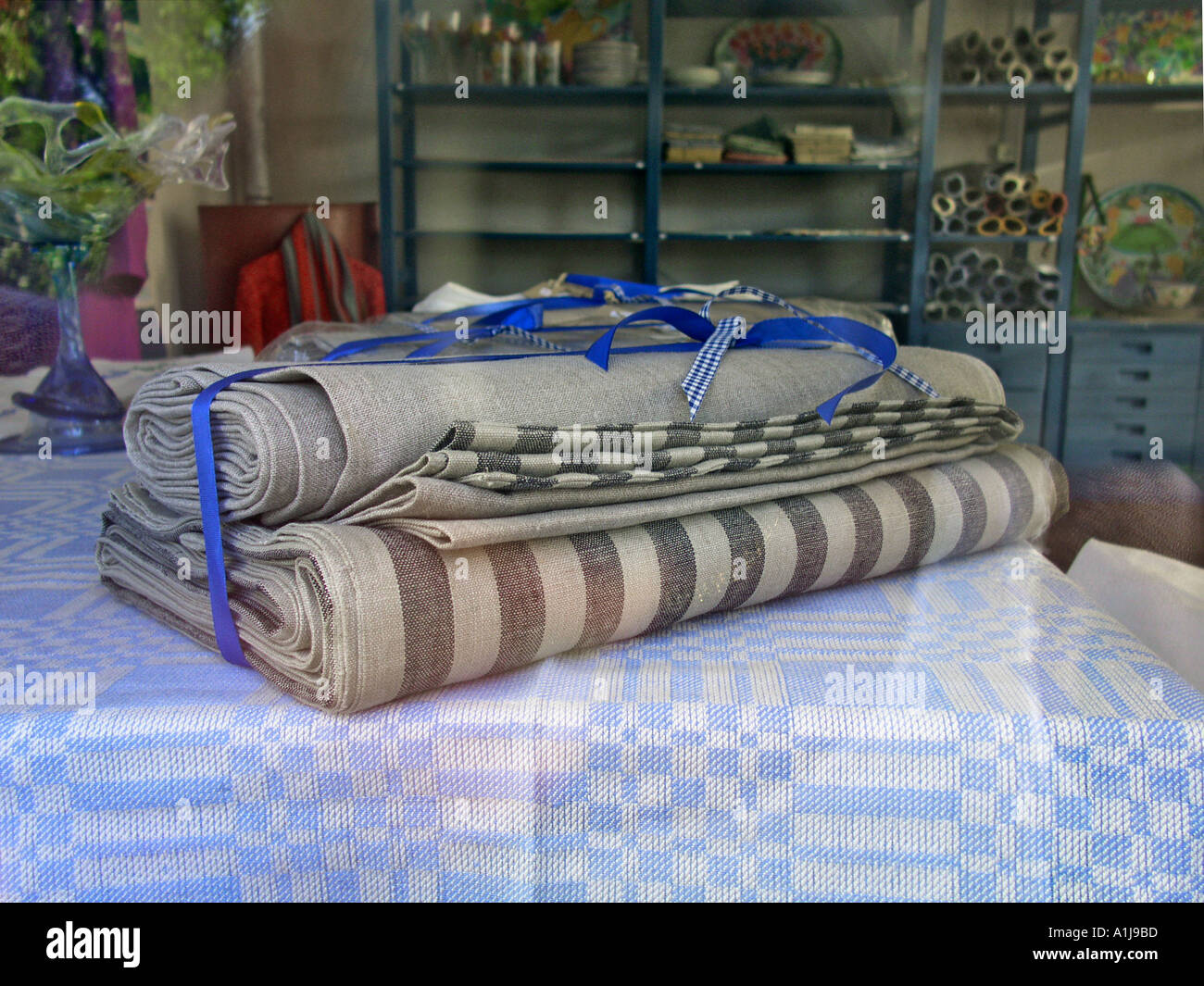 Pile of handwoven linen in shop window display Stock Photo - Alamy