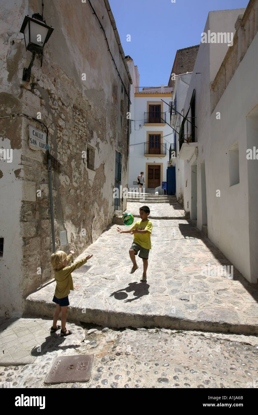 Local children play football on the streets of Ibiza Old Town in Ibiza ...