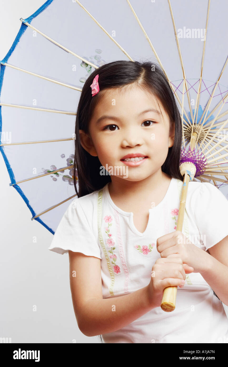 Portrait of a girl holding a parasol and smiling Stock Photo - Alamy