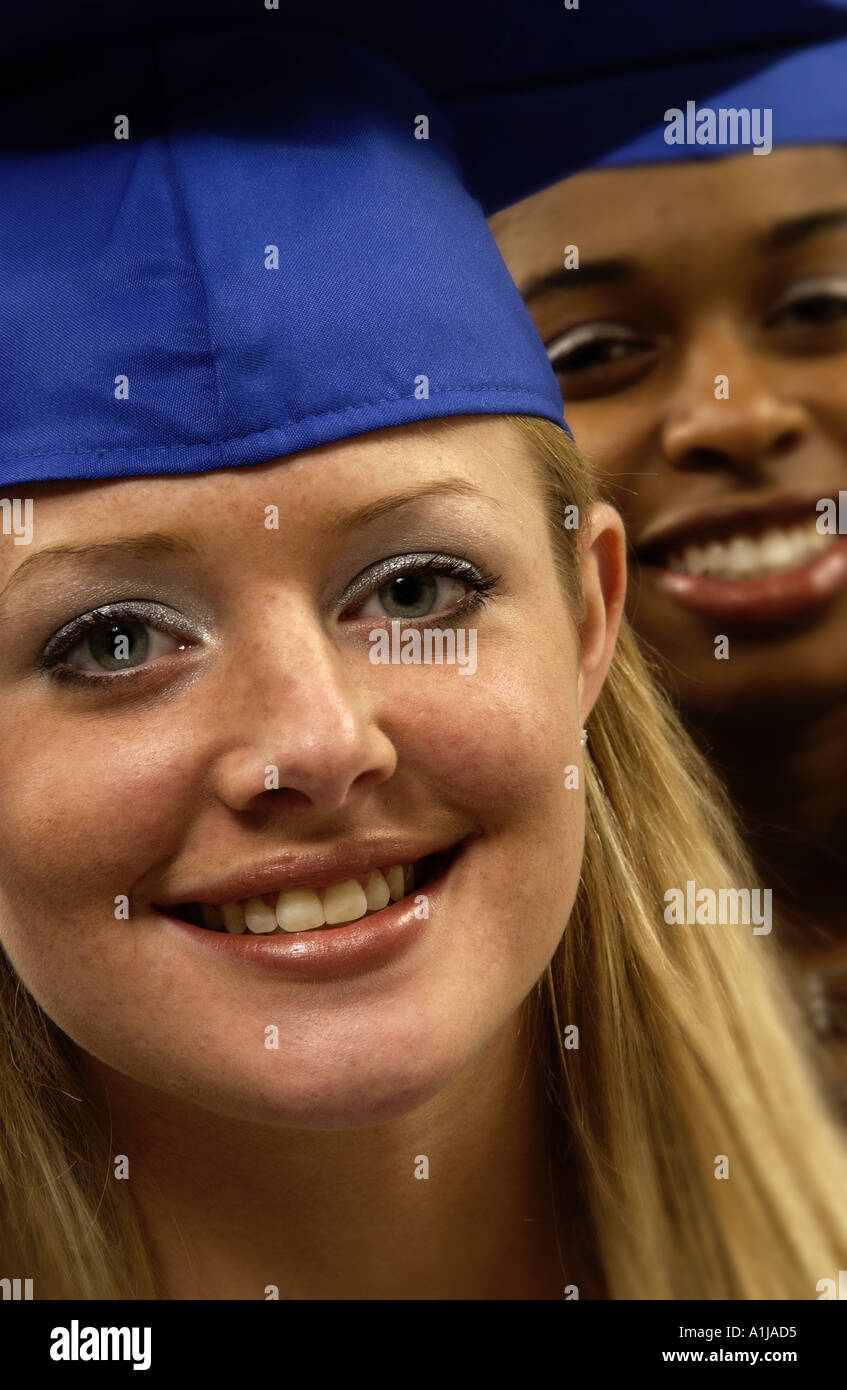Girls in cap and gown for graduation Stock Photo - Alamy