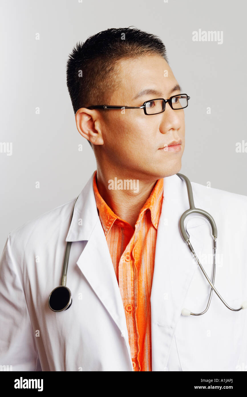 Close-up of a male doctor looking sideways and thinking Stock Photo - Alamy