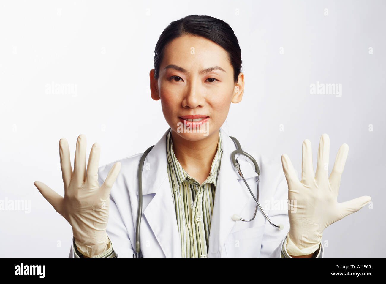 Portrait of a female doctor wearing surgical gloves Stock Photo - Alamy