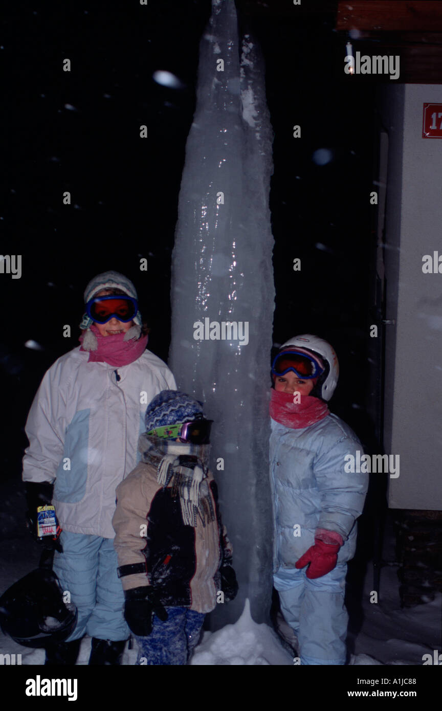 Three children aged nine seven and four stand beside giant icicle czech ...