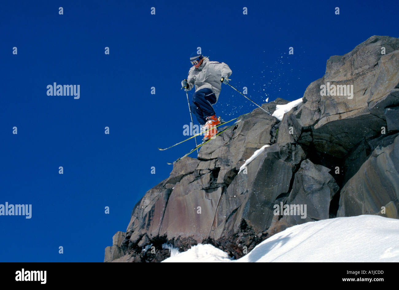 Snow skier flying off cliff Stock Photo - Alamy