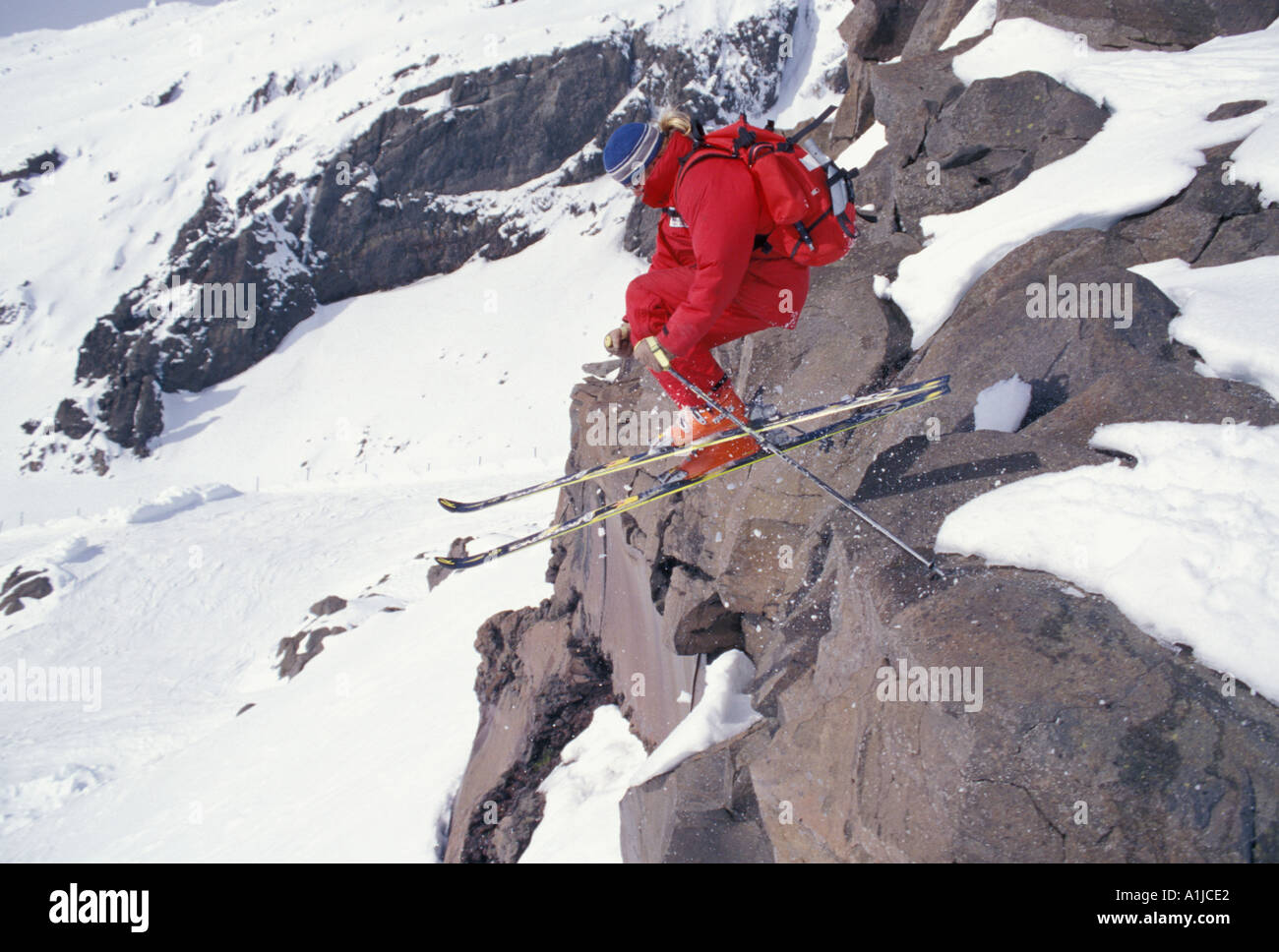 Snow skier flying off cliff Stock Photo - Alamy