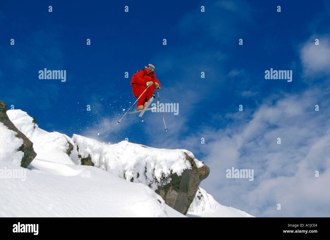 Snow skier flying off cliff Stock Photo - Alamy