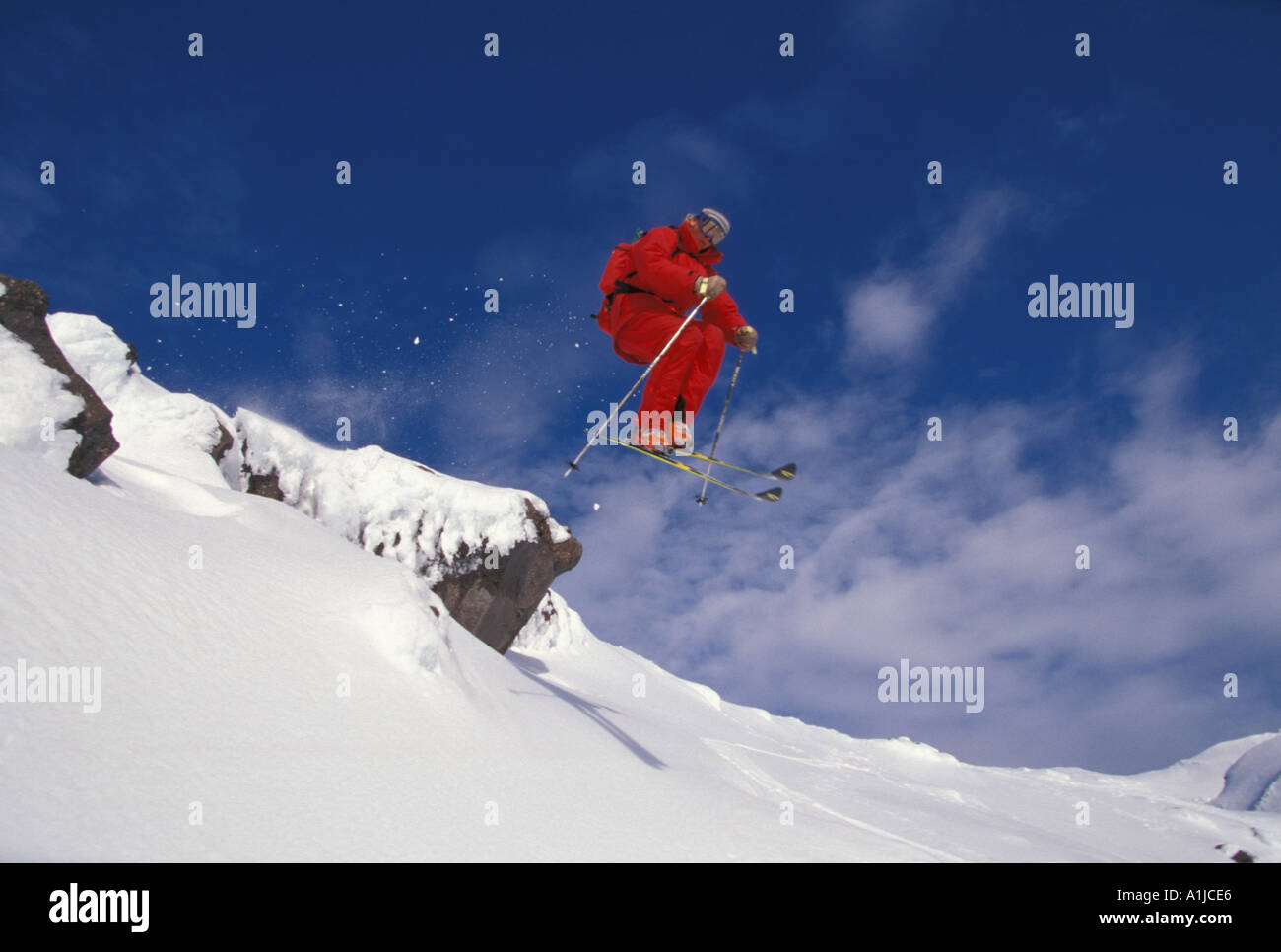 Snow skier flying off cliff Stock Photo - Alamy