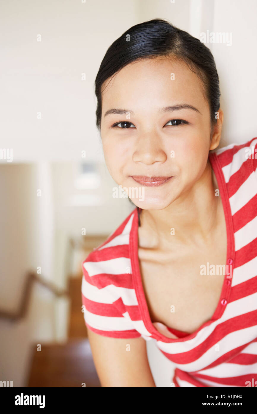 Portrait of a young woman smirking Stock Photo - Alamy