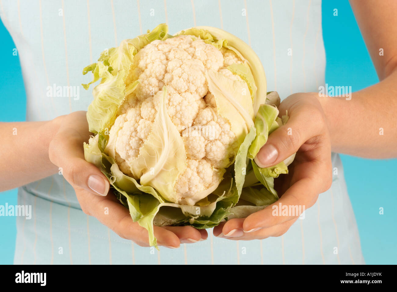WOMAN HOLDING WHOLE CAULIFLOWER Stock Photo - Alamy