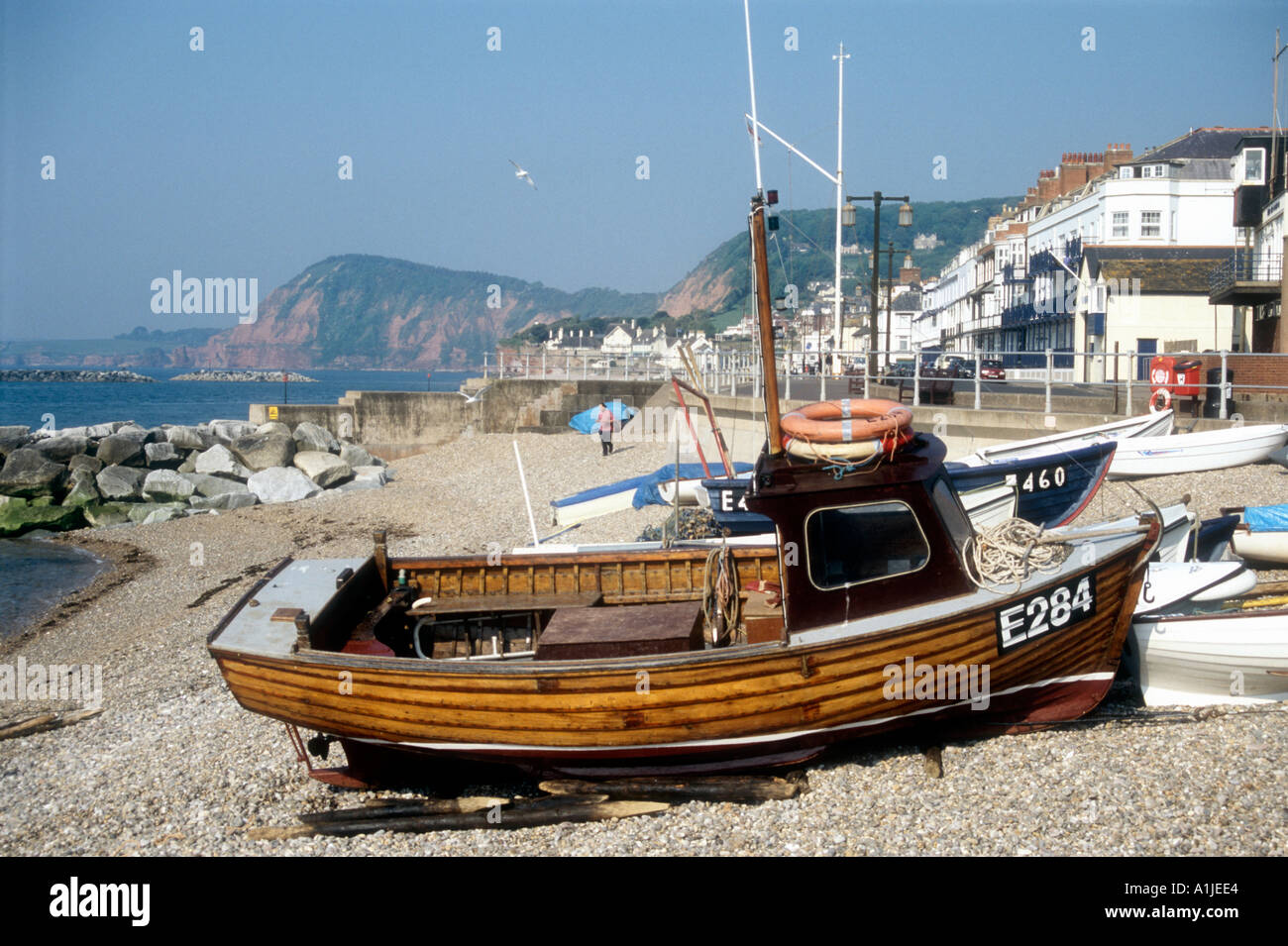 A traditional clinker built motor fishing boat on the seafront at ...